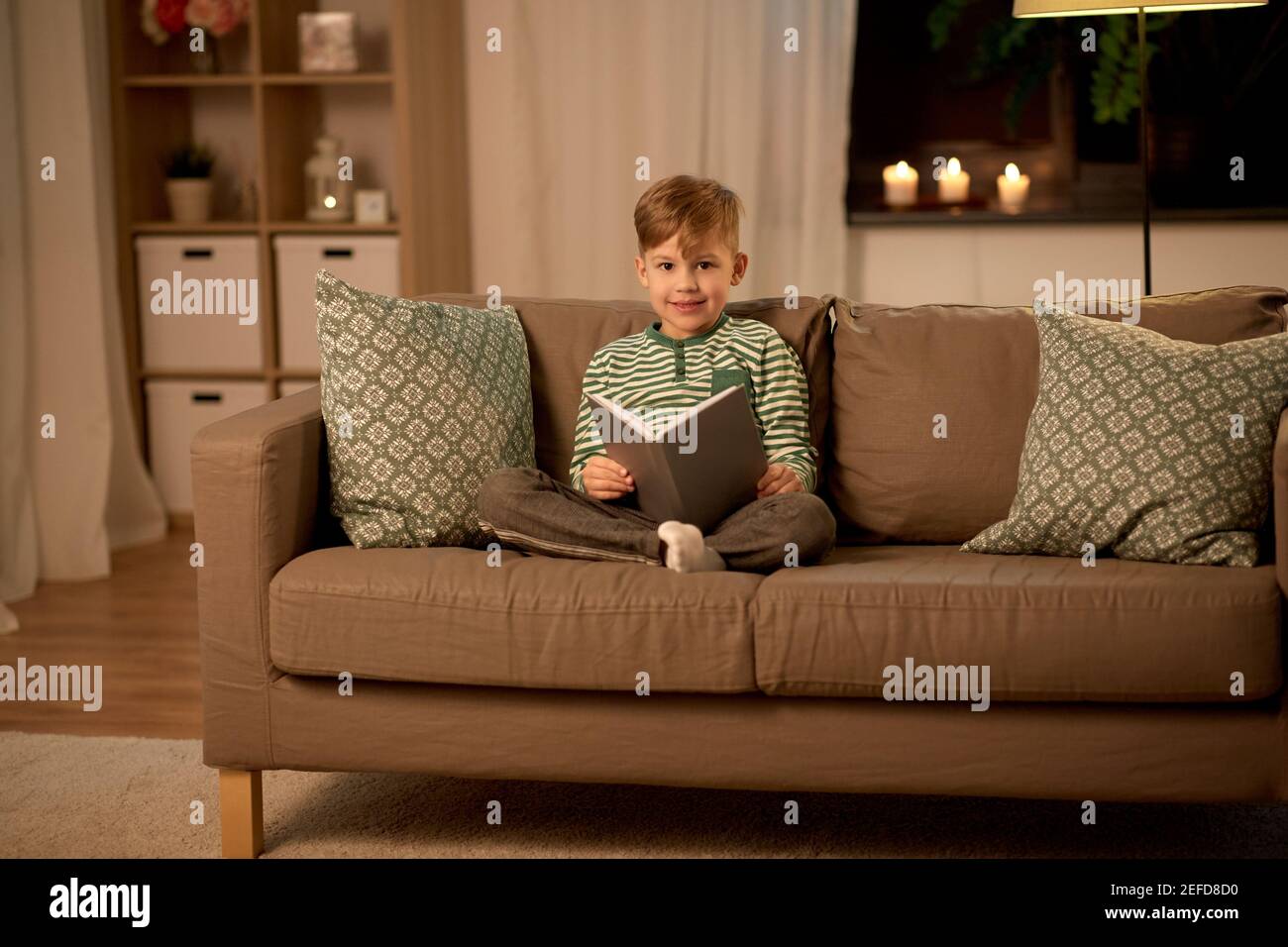 happy little boy reading book at home Stock Photo - Alamy