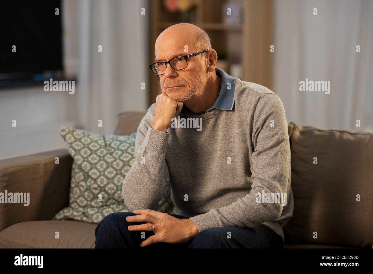 sad senior man in glasses thinking at home Stock Photo - Alamy