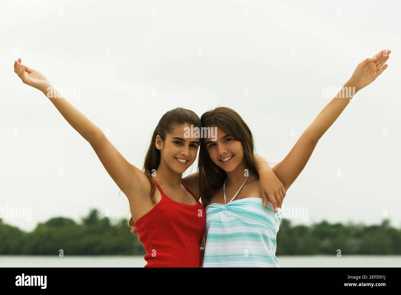 Portrait of two teenage girls with their arms around each other Stock ...