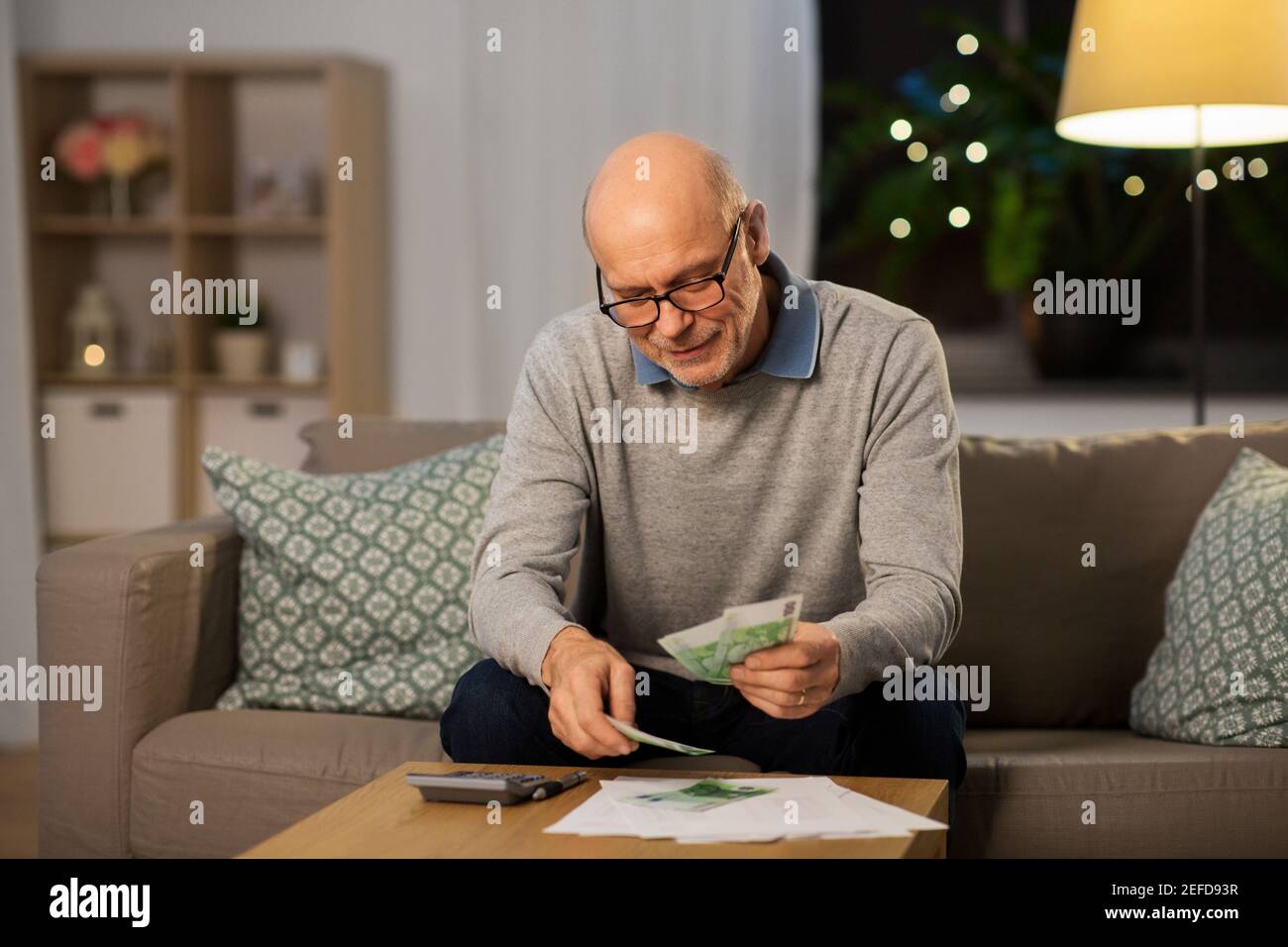senior man counting money at home Stock Photo - Alamy