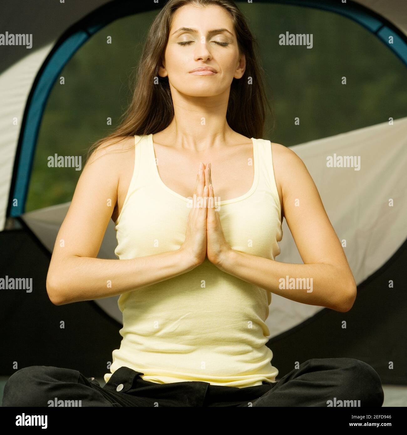 Young woman sitting in a prayer position Stock Photo - Alamy