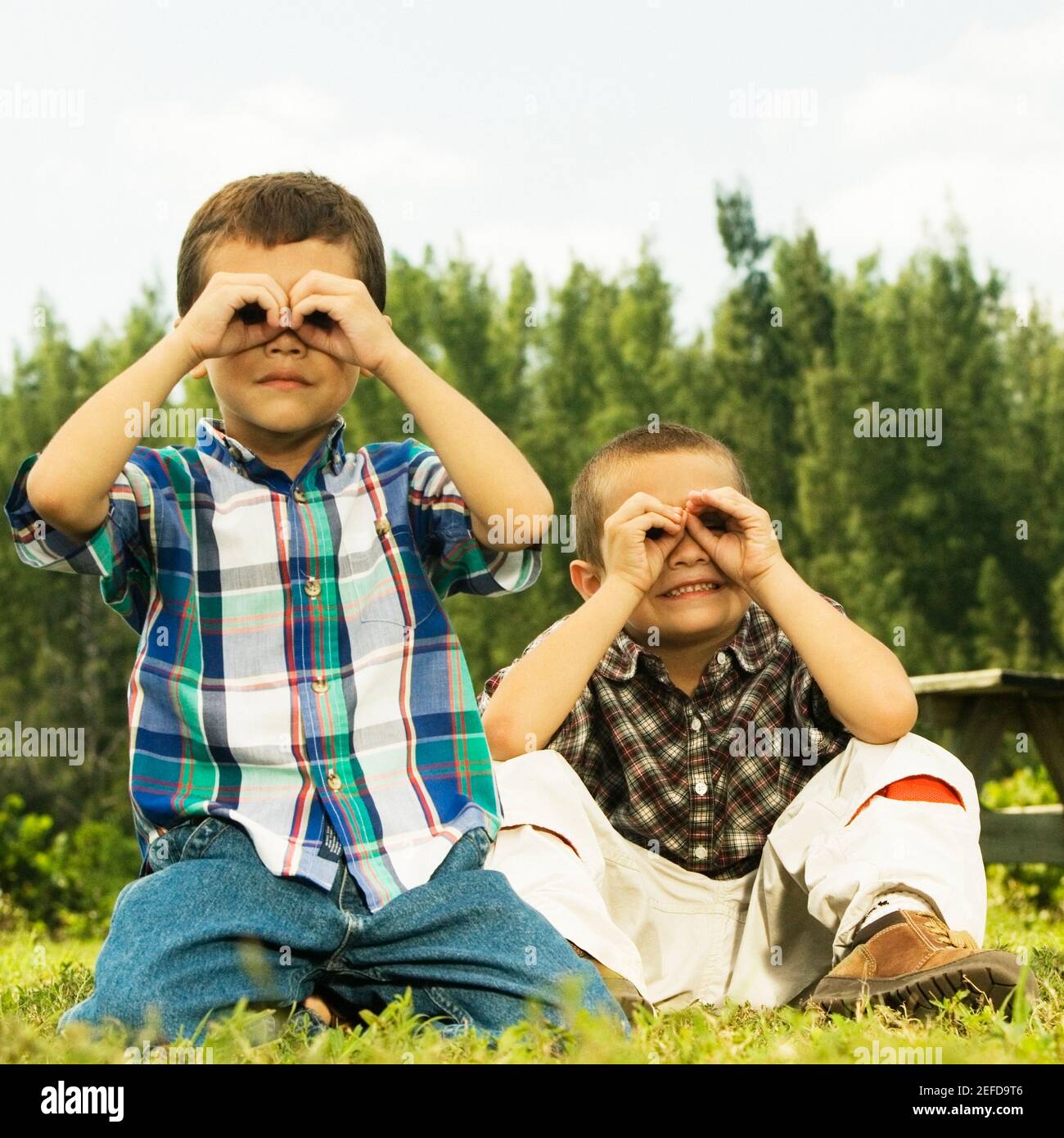 Close-up of two boys looking through their hands Stock Photo - Alamy