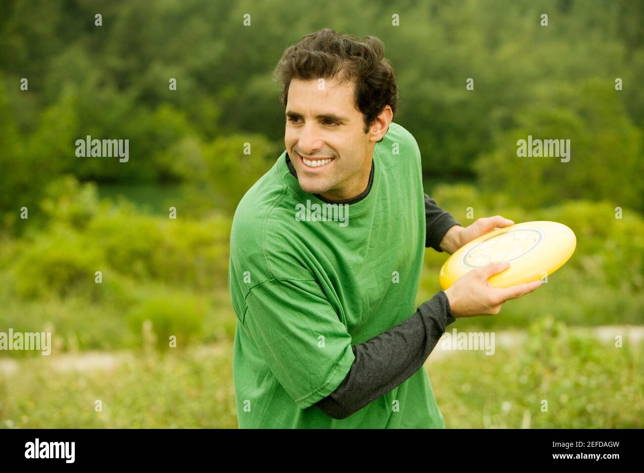 Close-up of a mid adult man throwing a plastic disc Stock Photo - Alamy