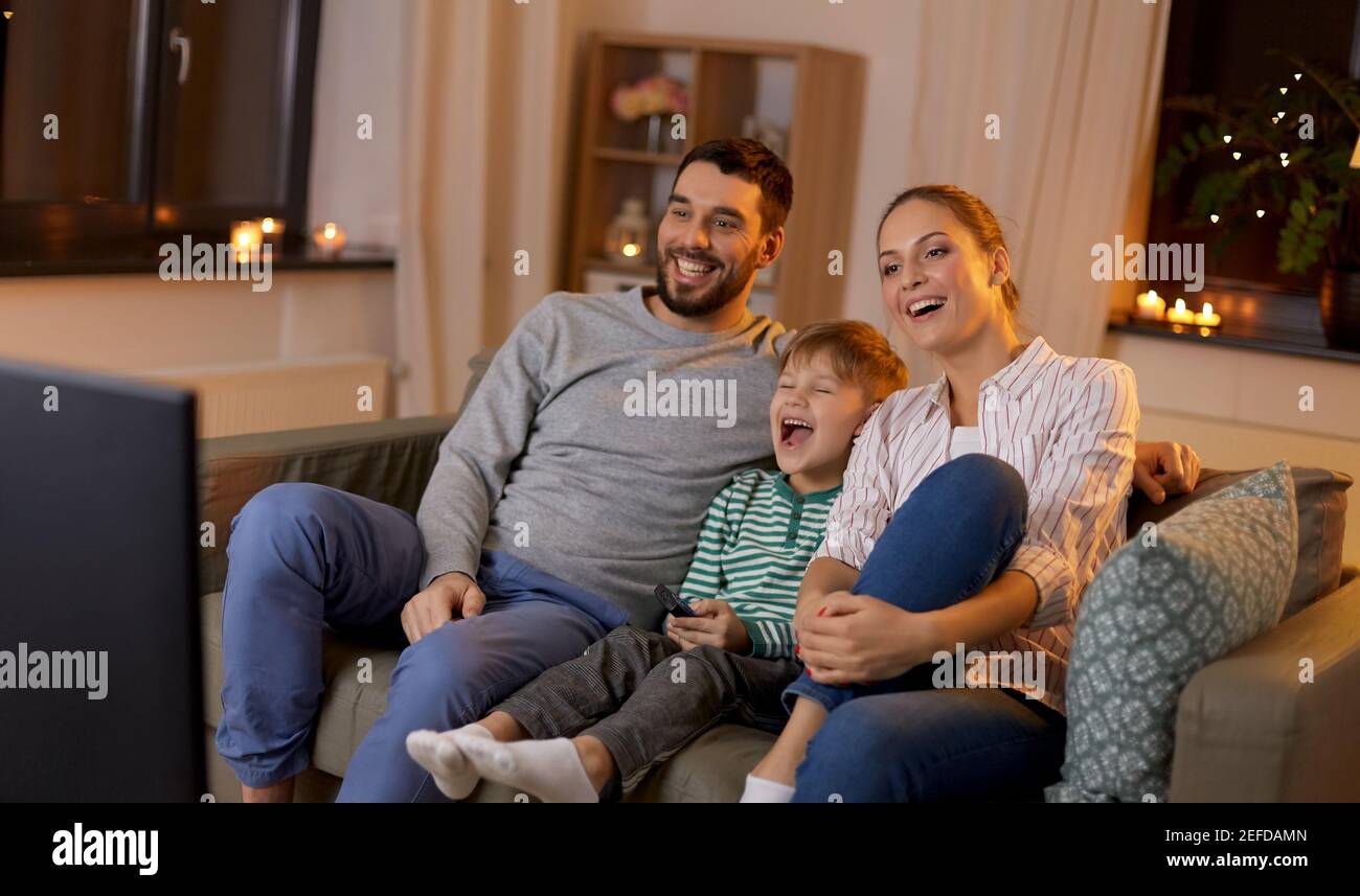 happy family watching tv at home at night Stock Photo - Alamy