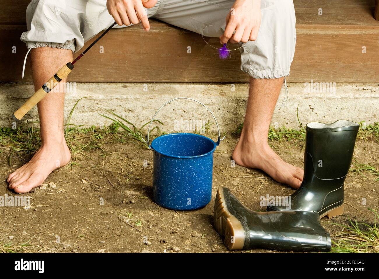 Man sitting on bucket fishing hi-res stock photography and images - Alamy