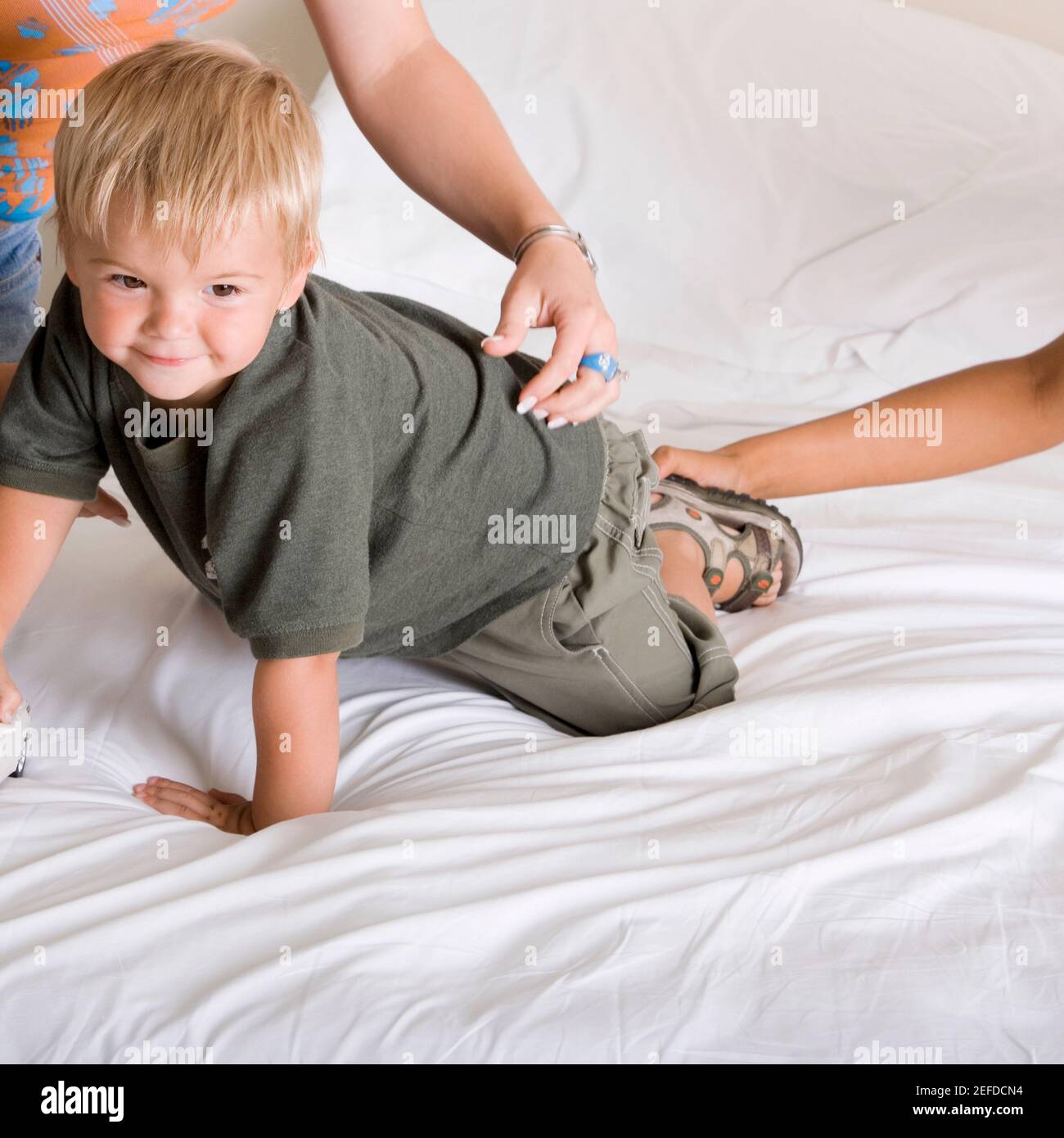Boy crawling on a bed Stock Photo - Alamy