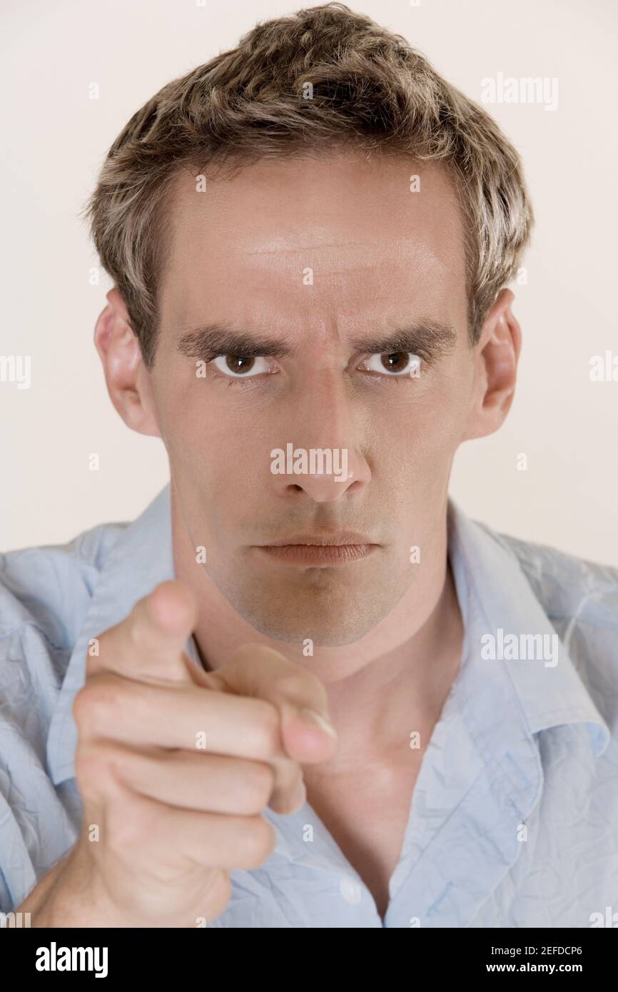 Portrait of a young man pointing forward Stock Photo - Alamy