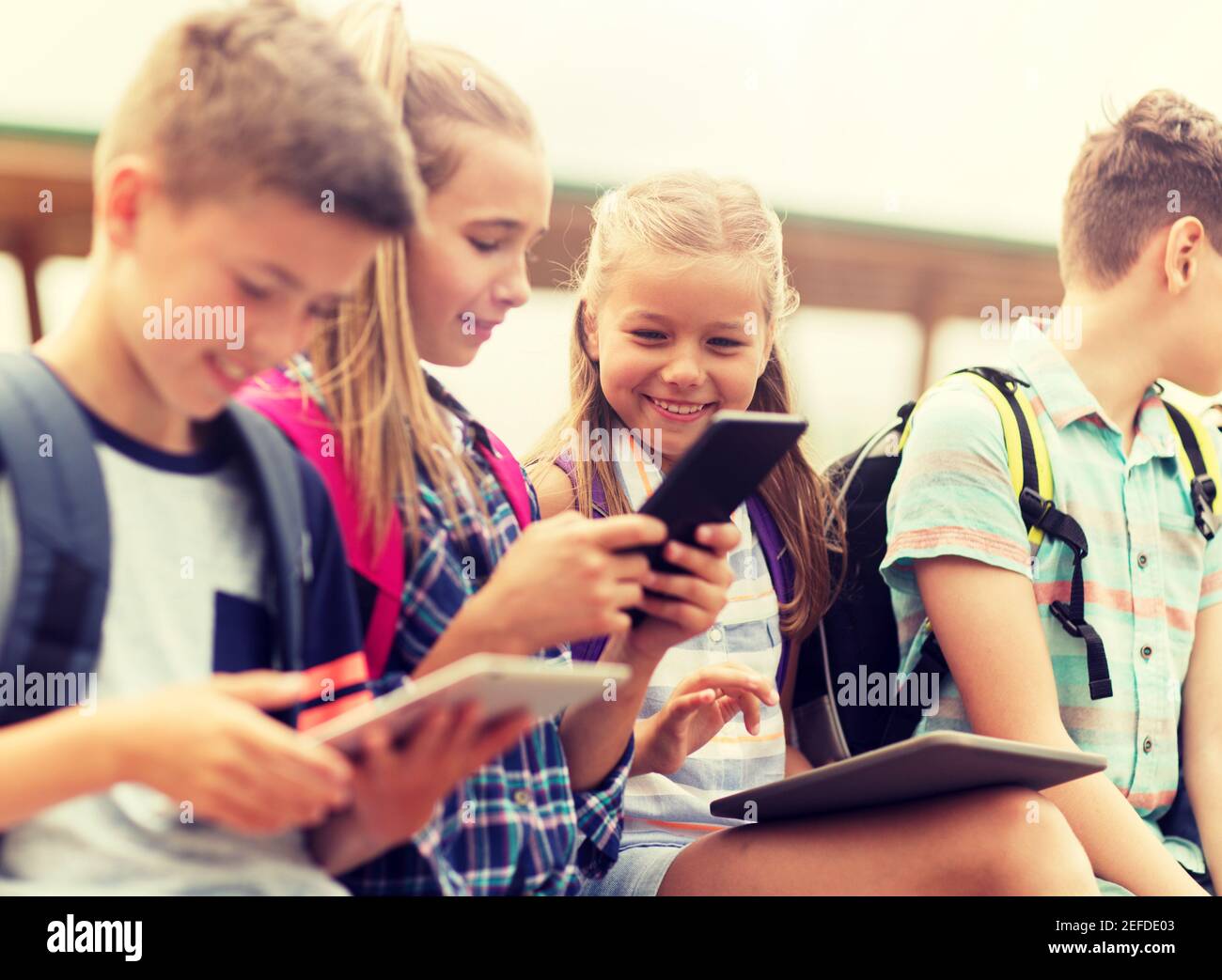 group of happy elementary school students talking Stock Photo - Alamy