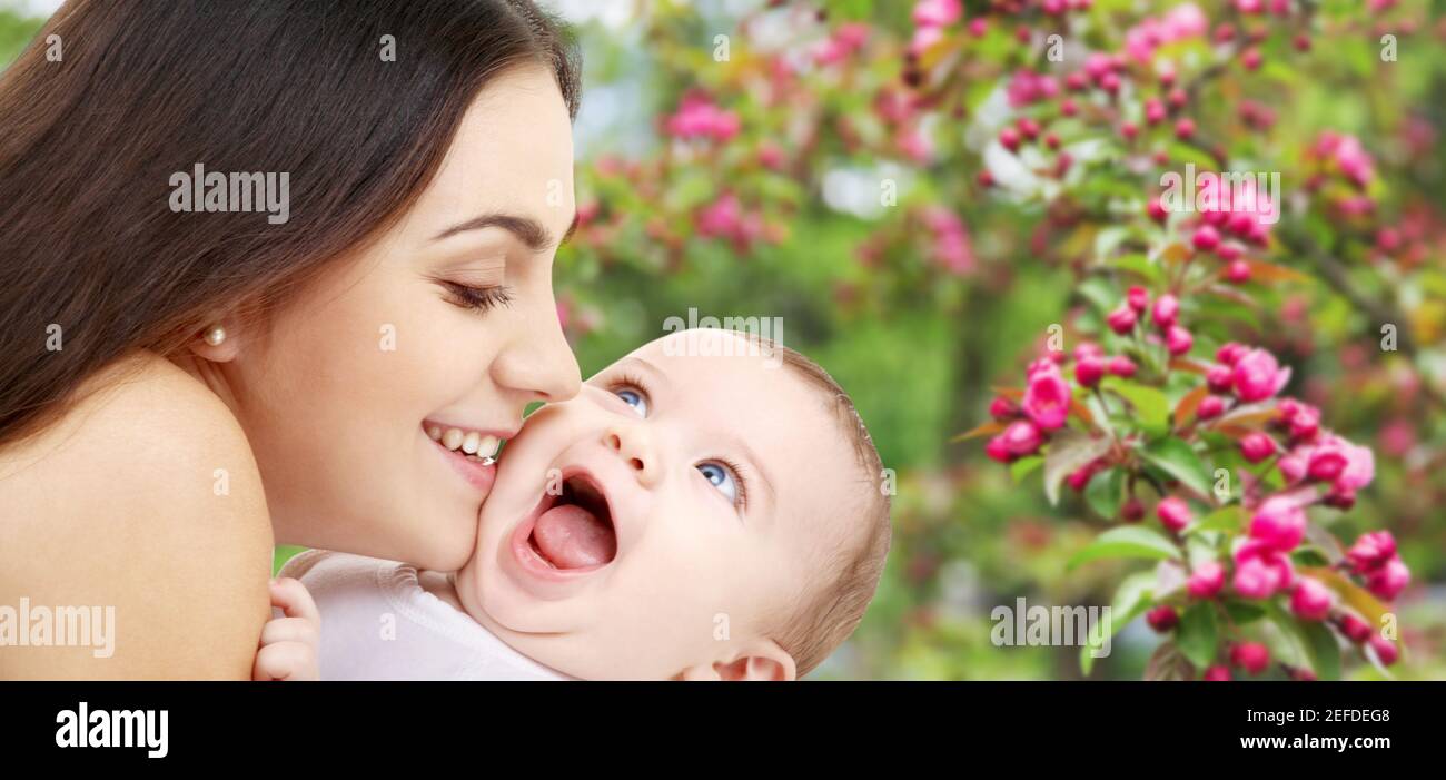 mother with baby over spring garden background Stock Photo - Alamy