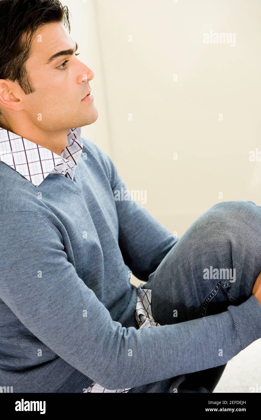 Side profile of a mid adult man sitting on the floor Stock Photo - Alamy