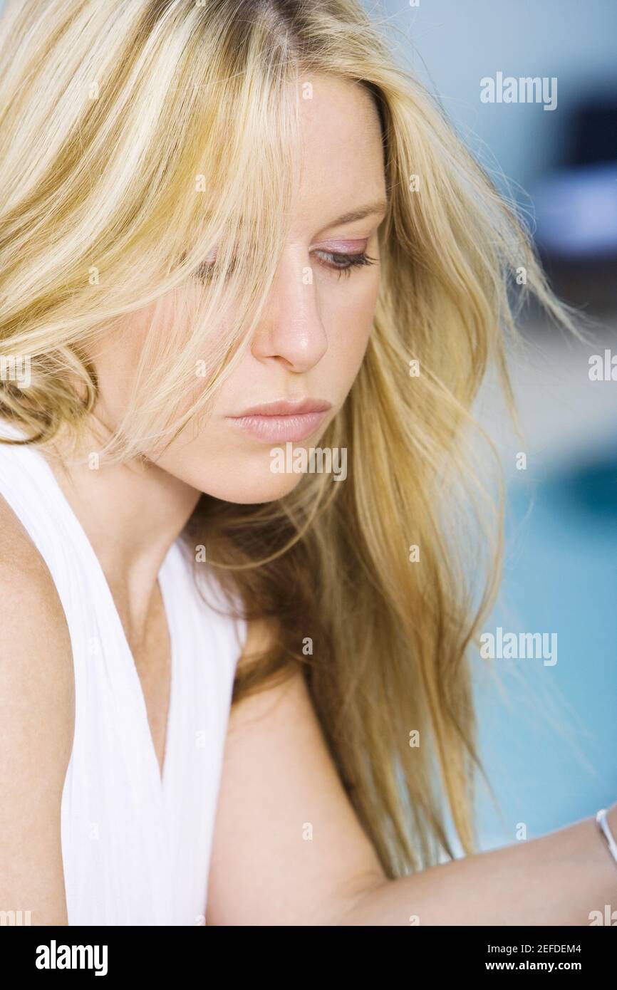 Close-up of a young woman looking down Stock Photo - Alamy
