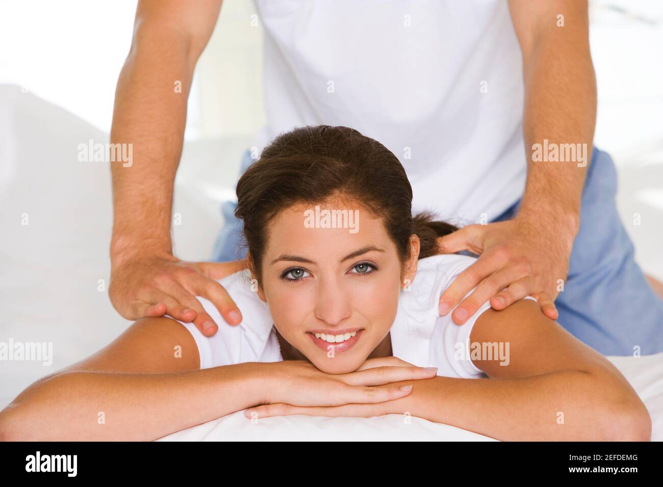 Portrait of a young woman getting a shoulder massage Stock Photo - Alamy