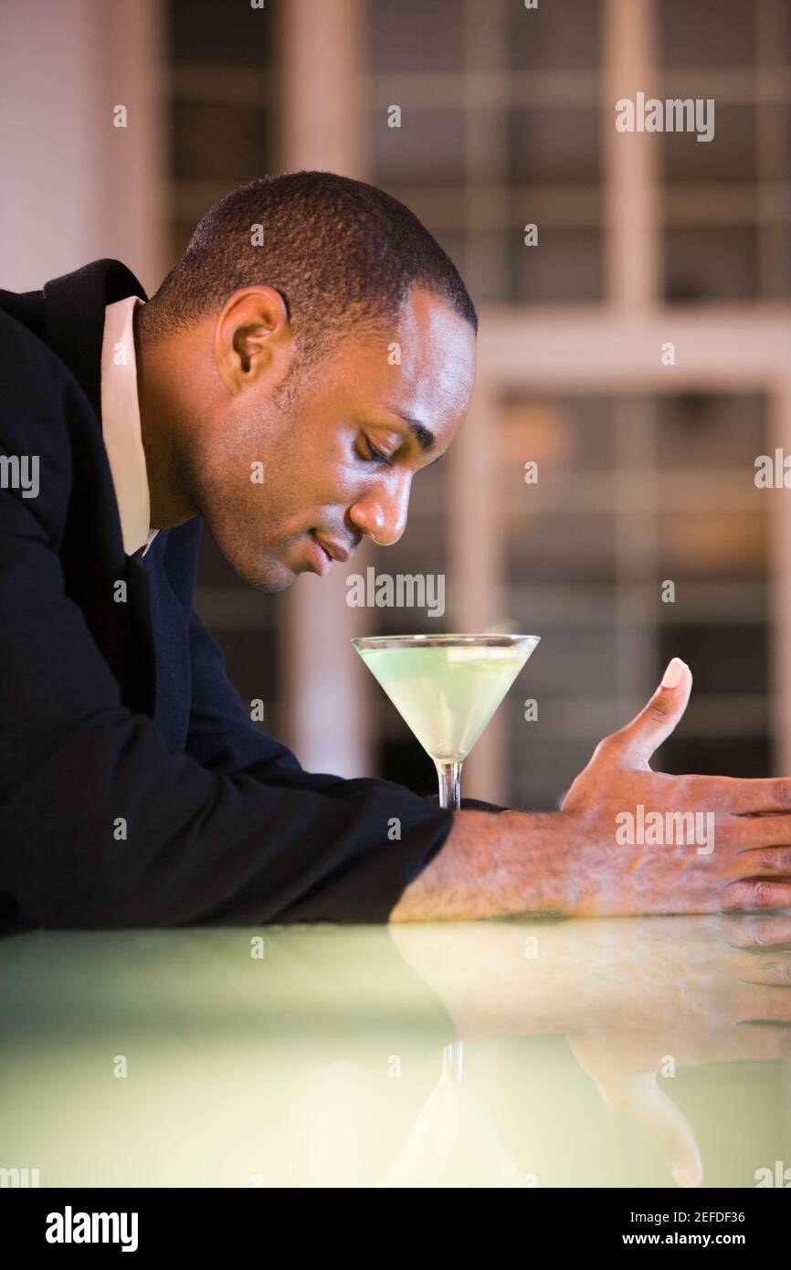 Side profile of a businessman with a martini in front of him Stock ...
