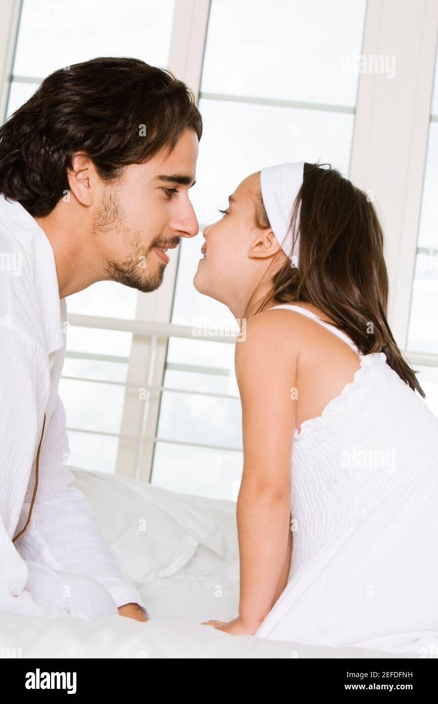 Side profile of a father looking at his daughter Stock Photo - Alamy