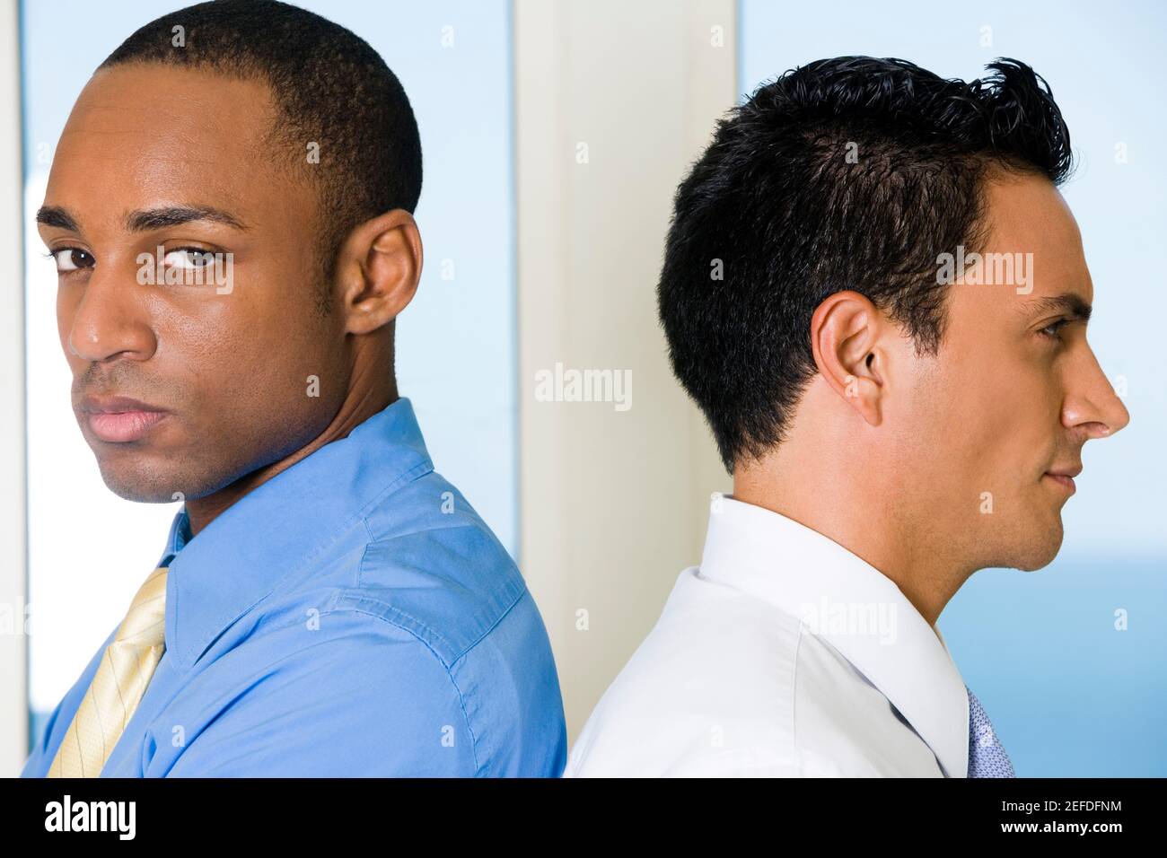 Side profile of two businessmen back to back Stock Photo - Alamy