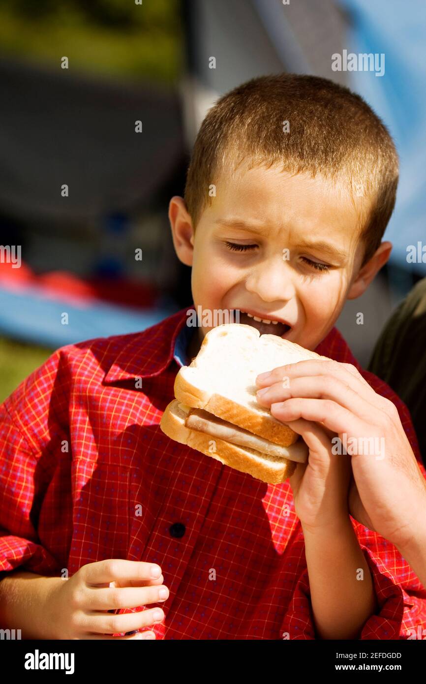 Boy eating a sandwich hi-res stock photography and images - Alamy