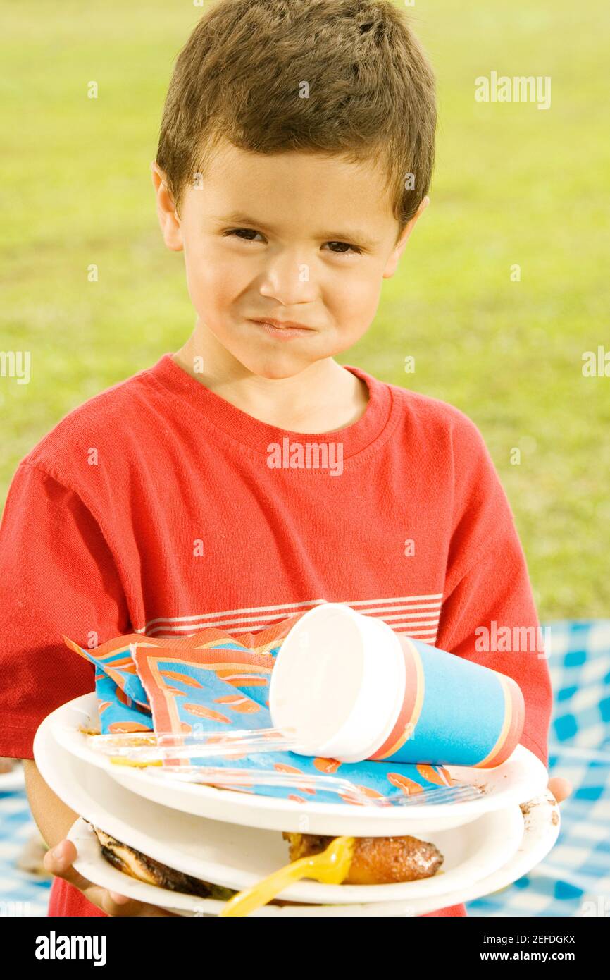Portrait of a boy holding plates Stock Photo - Alamy