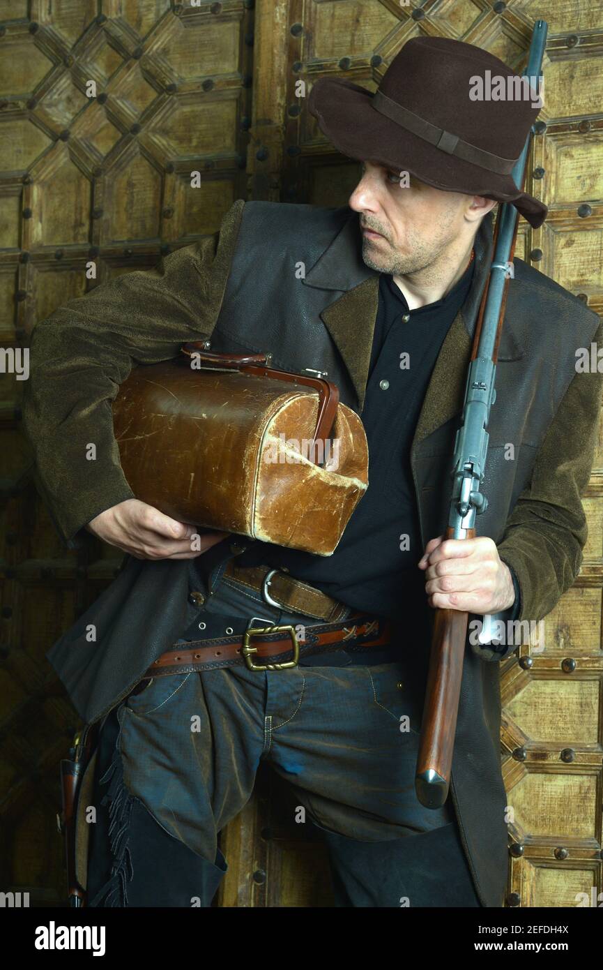 Bandit with gun in the wild west Stock Photo - Alamy