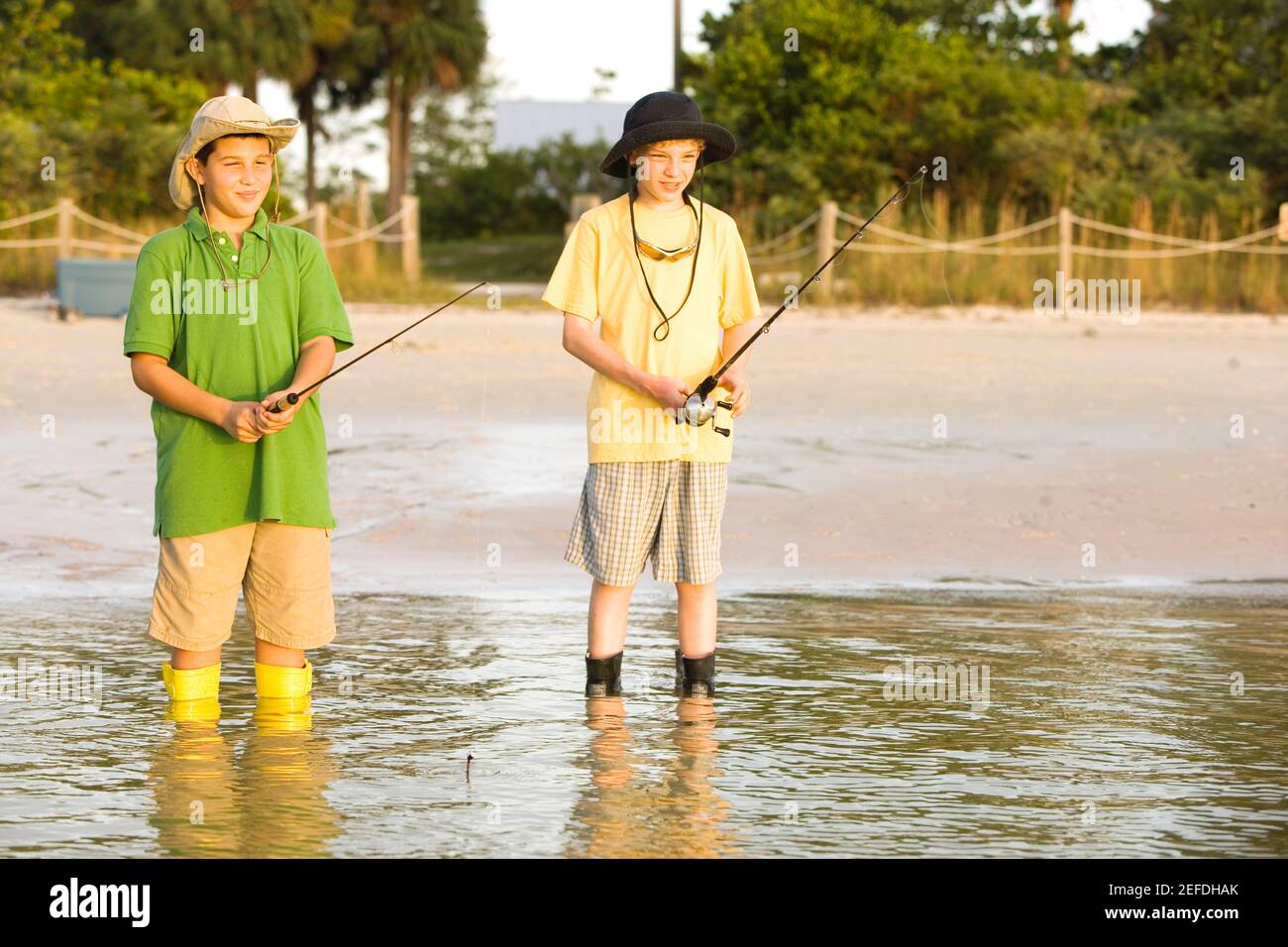 Two boys fishing in a lake Stock Photo - Alamy