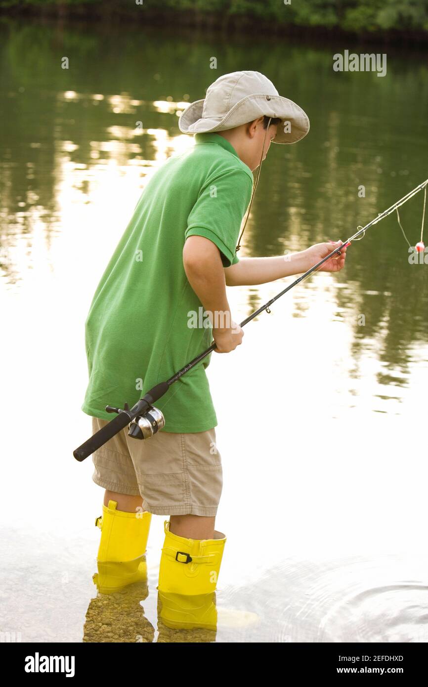 Side profile of a teenage boy holding a fishing rod Stock Photo - Alamy