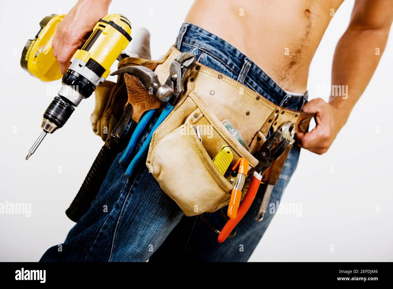 Mid section view of a man holding a drill machine Stock Photo - Alamy