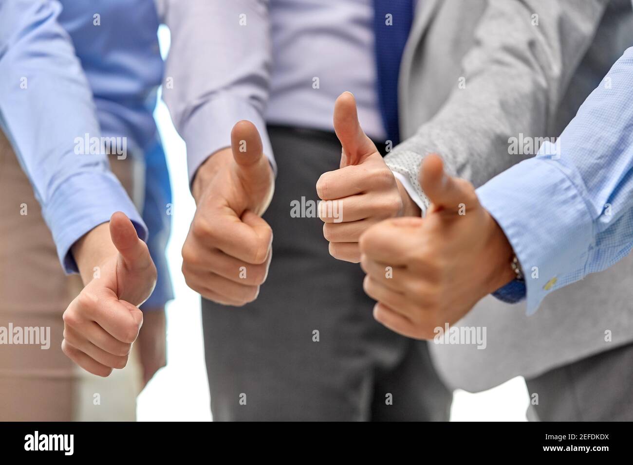 close up of business team hands showing thumbs up Stock Photo - Alamy