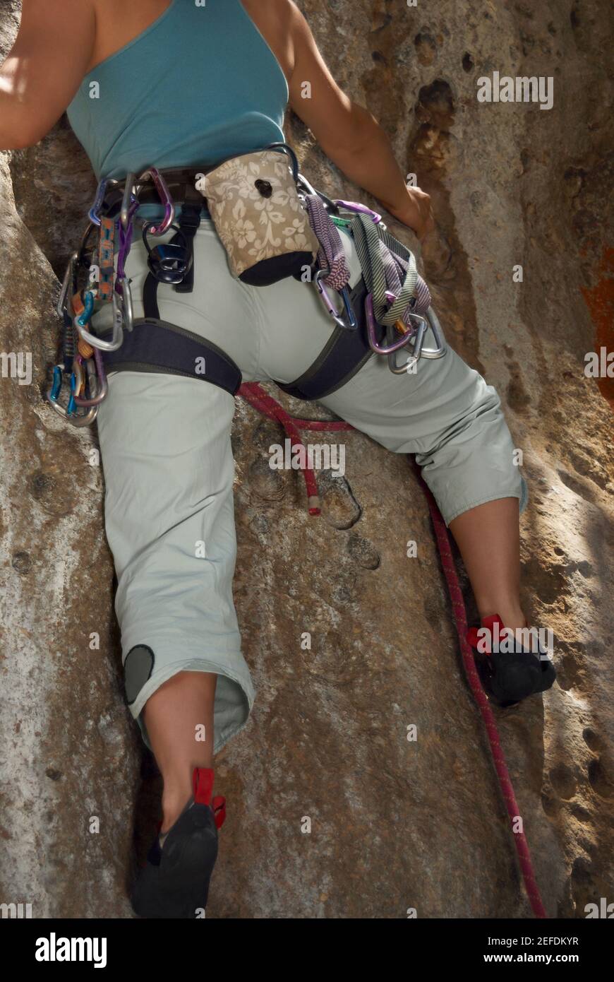 Low angle view of a female rock climber climbing a rock Stock Photo - Alamy