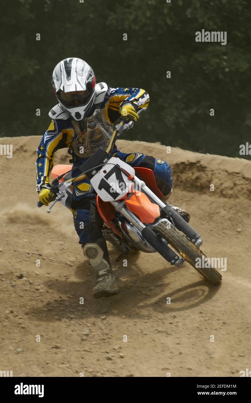 Motocross rider leaning into a turn Stock Photo - Alamy