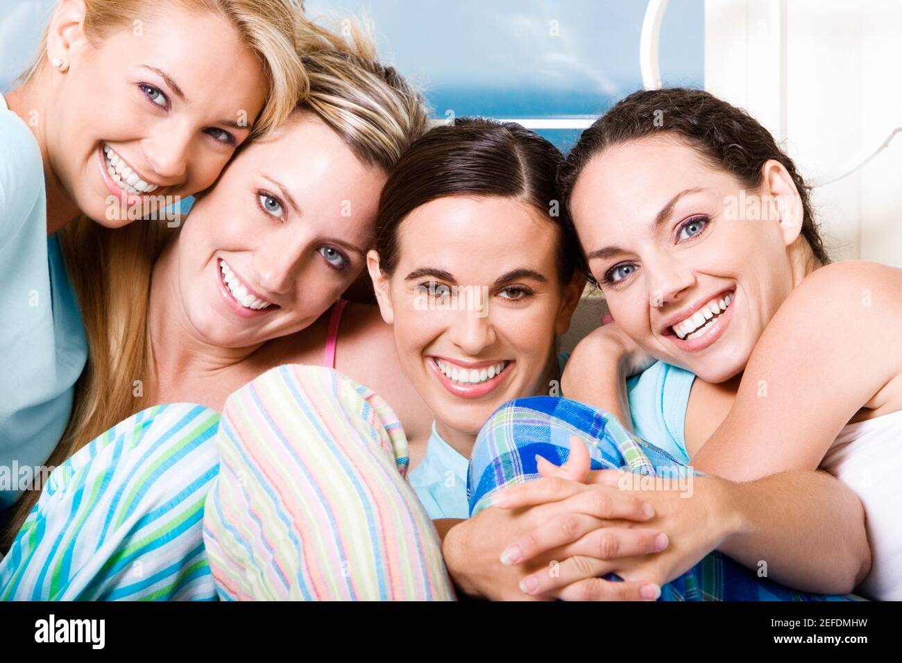 Portrait of four young women smiling Stock Photo - Alamy