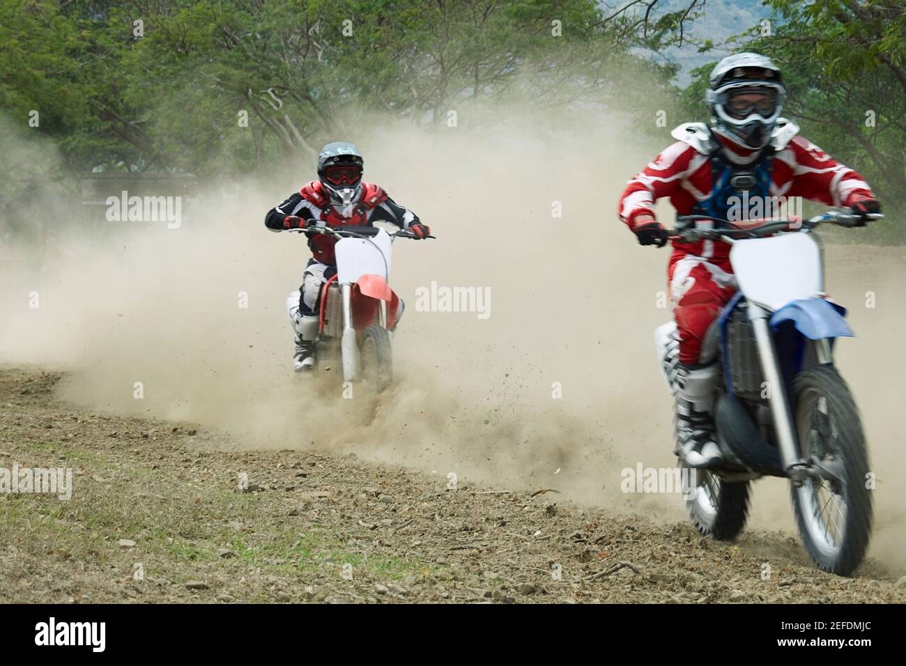 Two motocross riders riding motorcycles Stock Photo - Alamy