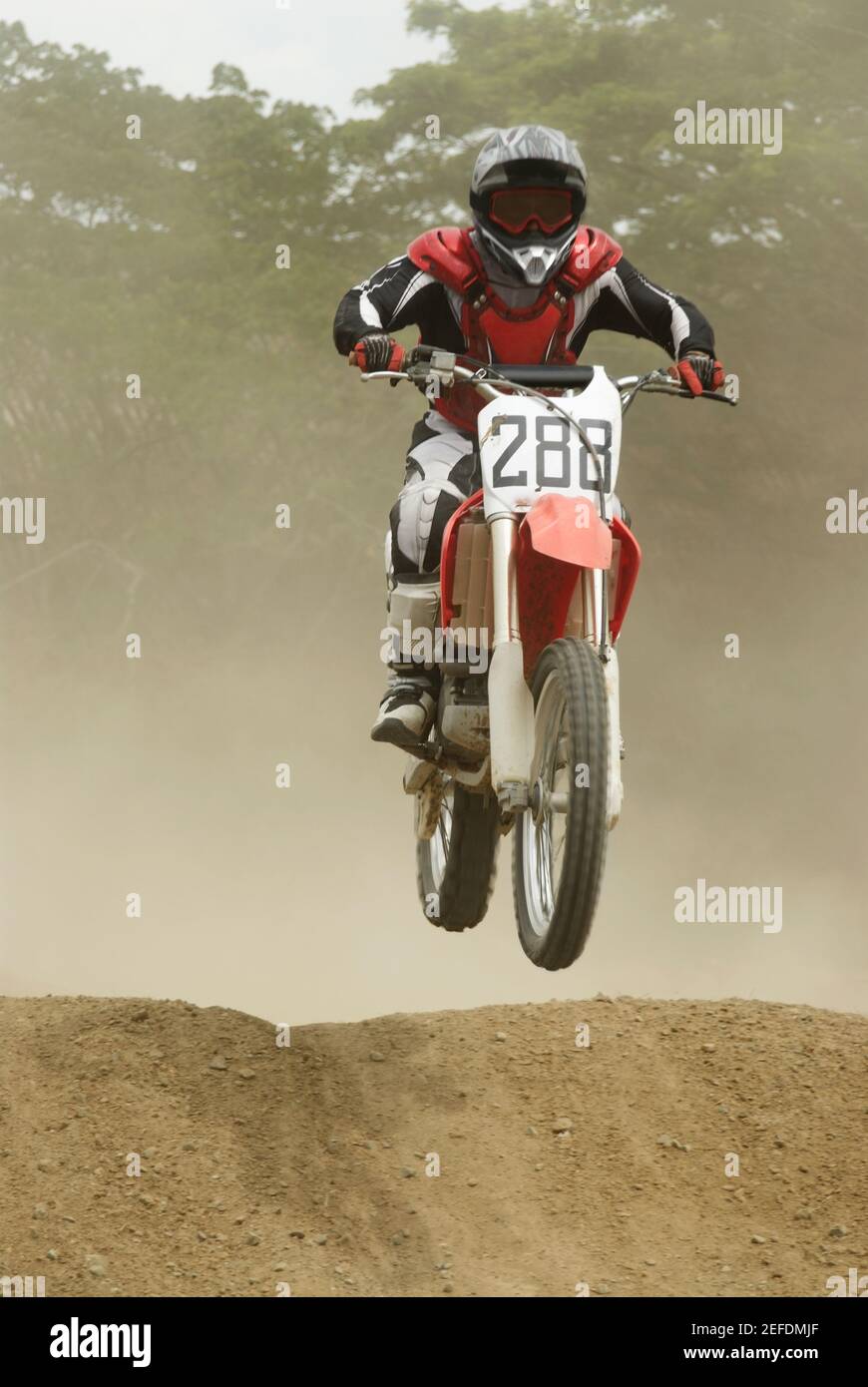 Motocross rider performing a jump on a motorcycle Stock Photo - Alamy