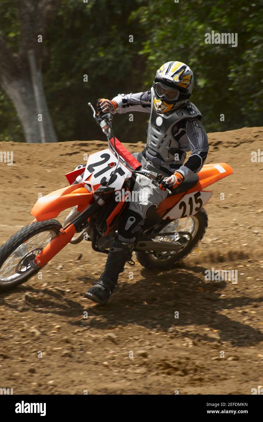 Motocross rider riding a motorcycle Stock Photo - Alamy