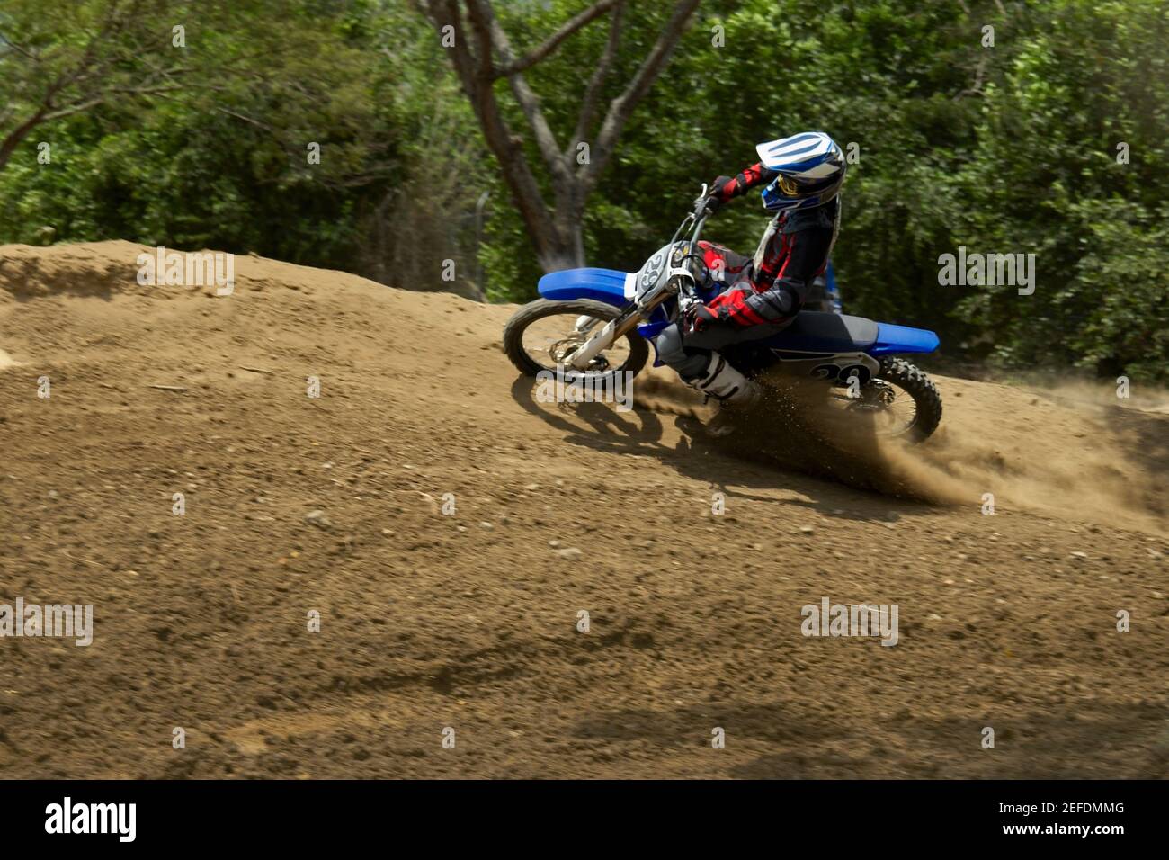 Side profile of a motocross rider riding a motorcycle Stock Photo - Alamy