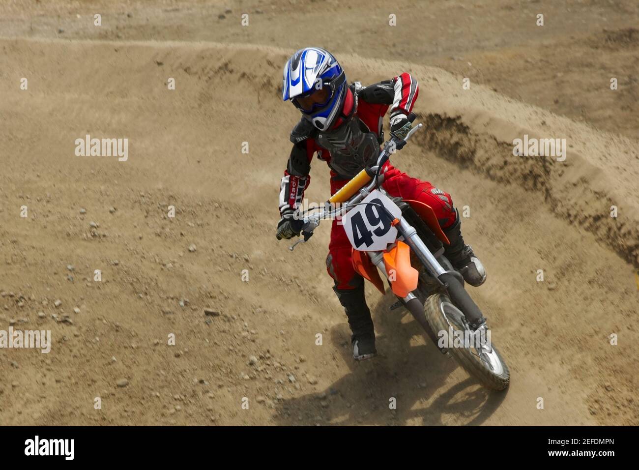 Motocross rider riding a motorcycle Stock Photo - Alamy