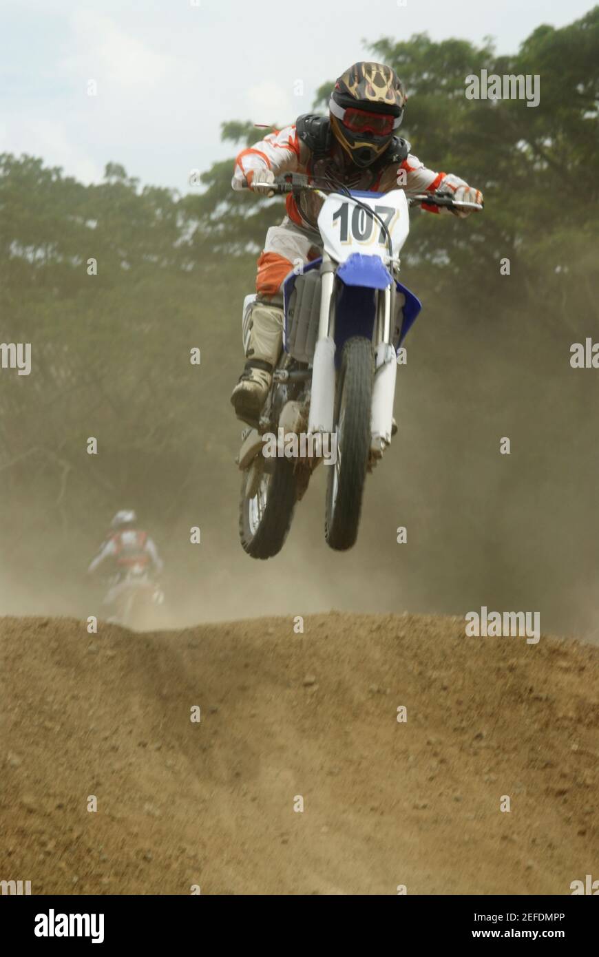 Motocross rider performing a jump on a motorcycle Stock Photo - Alamy