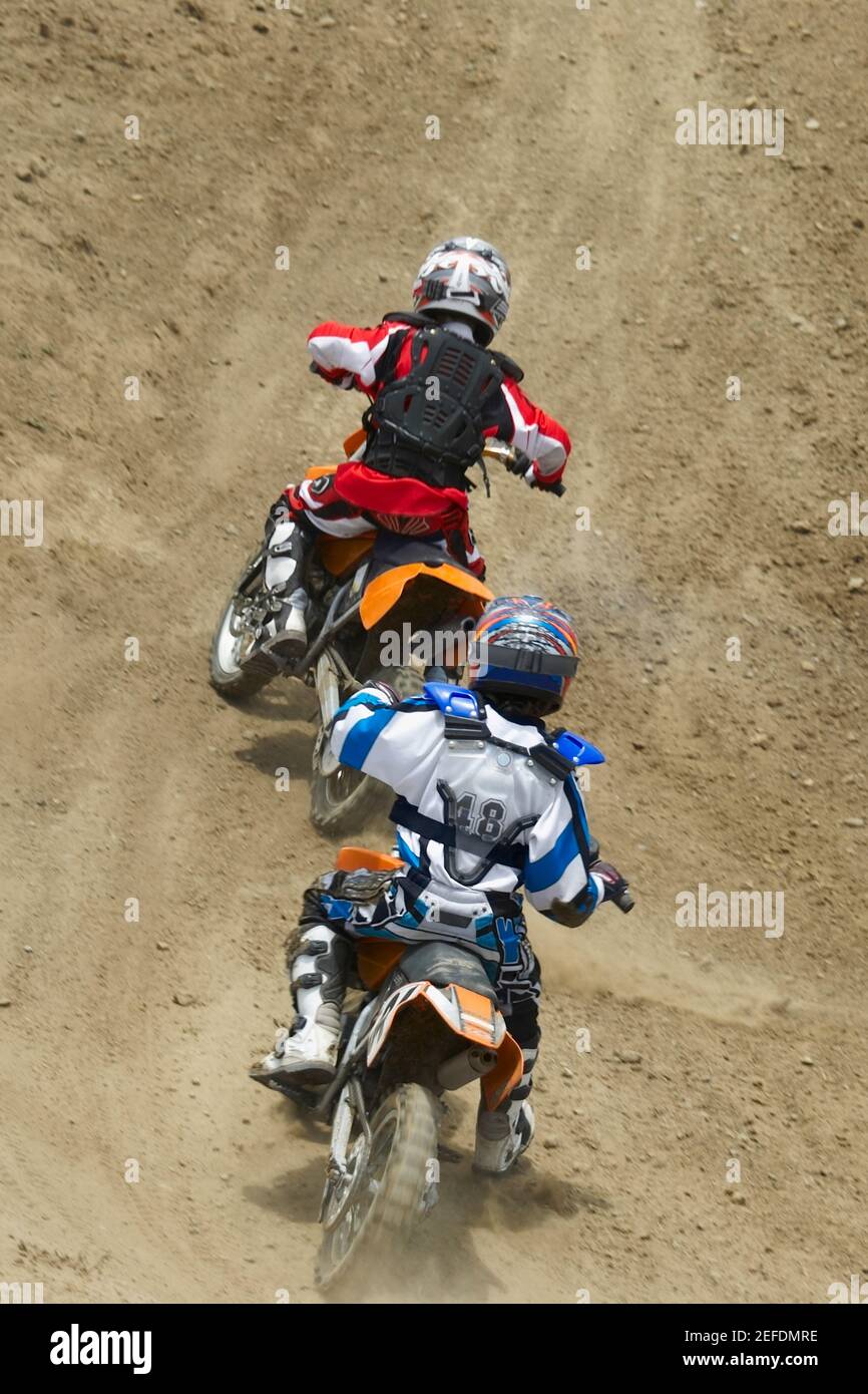 Two motocross riders riding motorcycles Stock Photo - Alamy