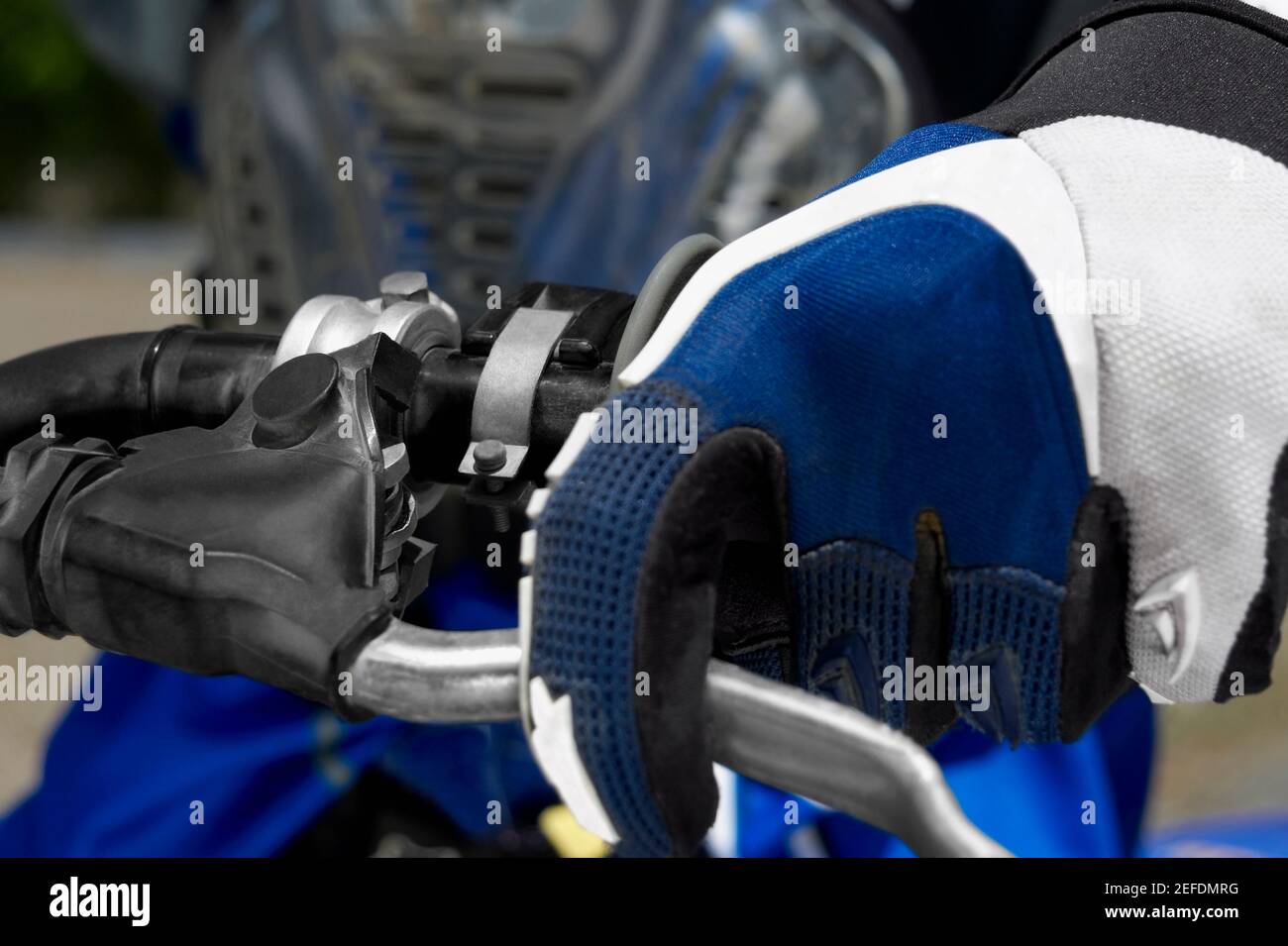 Close-up of a motocross riderÅ½s hand on the handlebar of a motorcycle ...