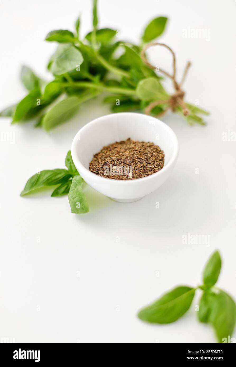 fresh basil and dry seasoning on white background Stock Photo - Alamy