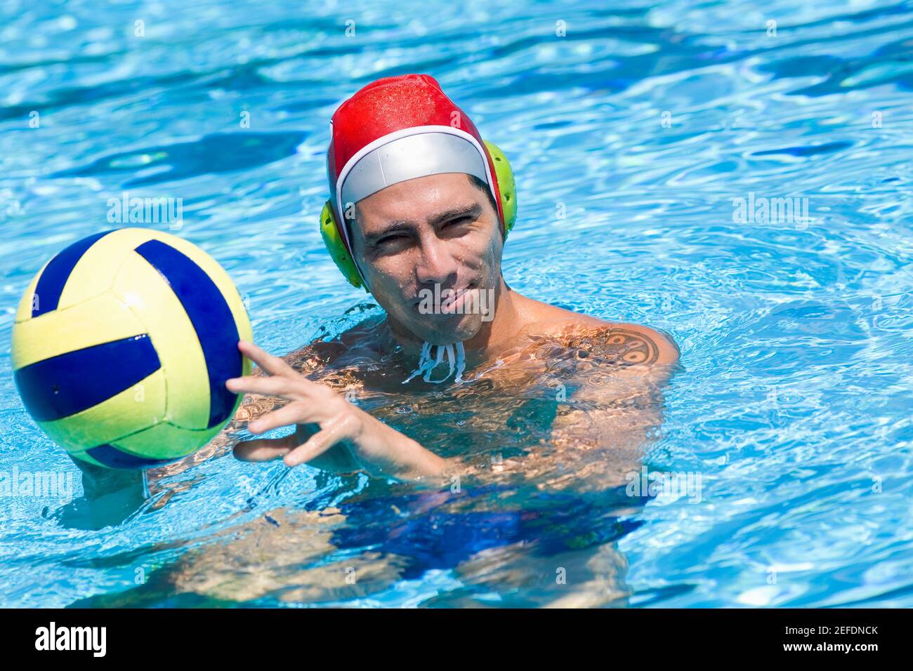 Portrait of a mid adult man holding a ball in a swimming pool Stock ...