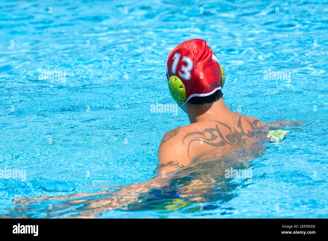 Rear view of a mid adult man in a swimming pool Stock Photo - Alamy
