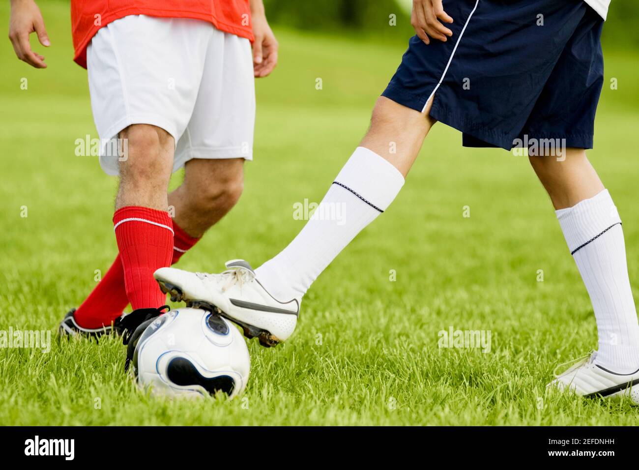 Low section view of two soccer players playing soccer Stock Photo - Alamy