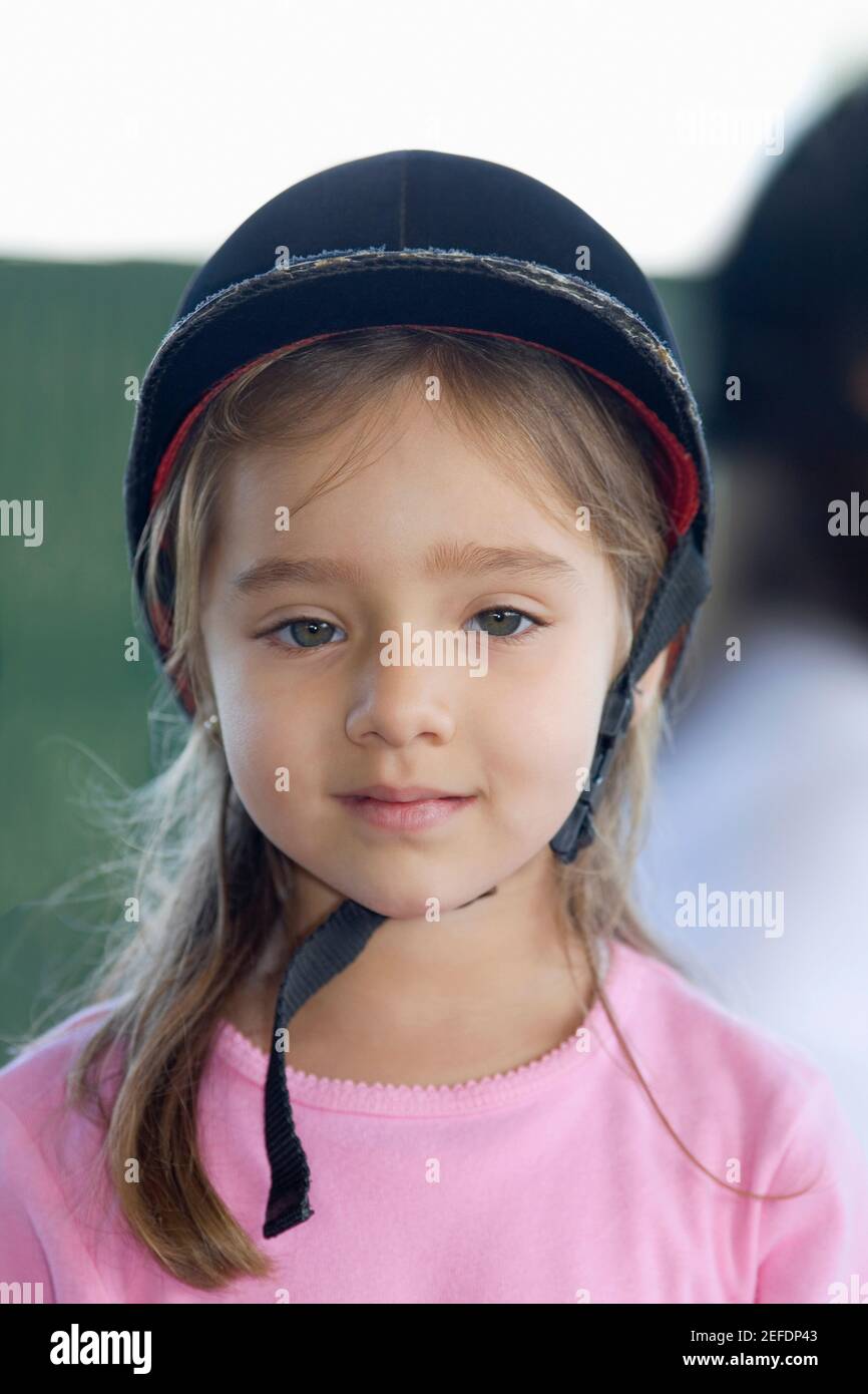 Portrait of a girl wearing a riding hat Stock Photo - Alamy