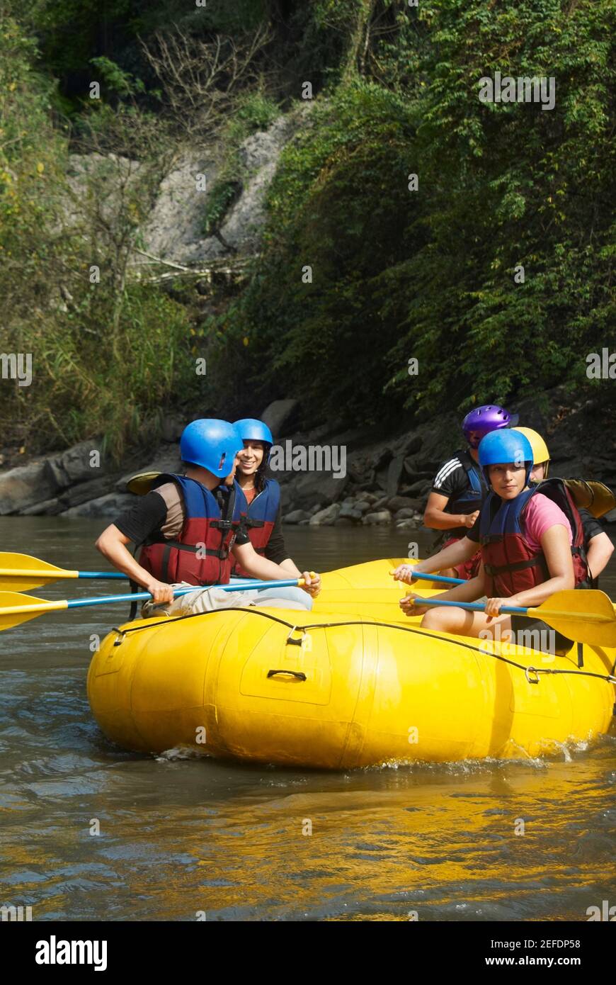 Five people rafting in a river Stock Photo - Alamy