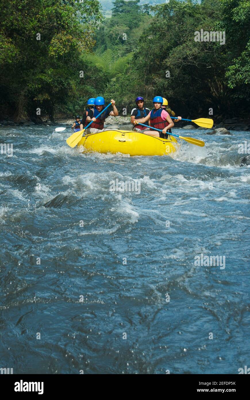 Five people rafting in a river Stock Photo - Alamy
