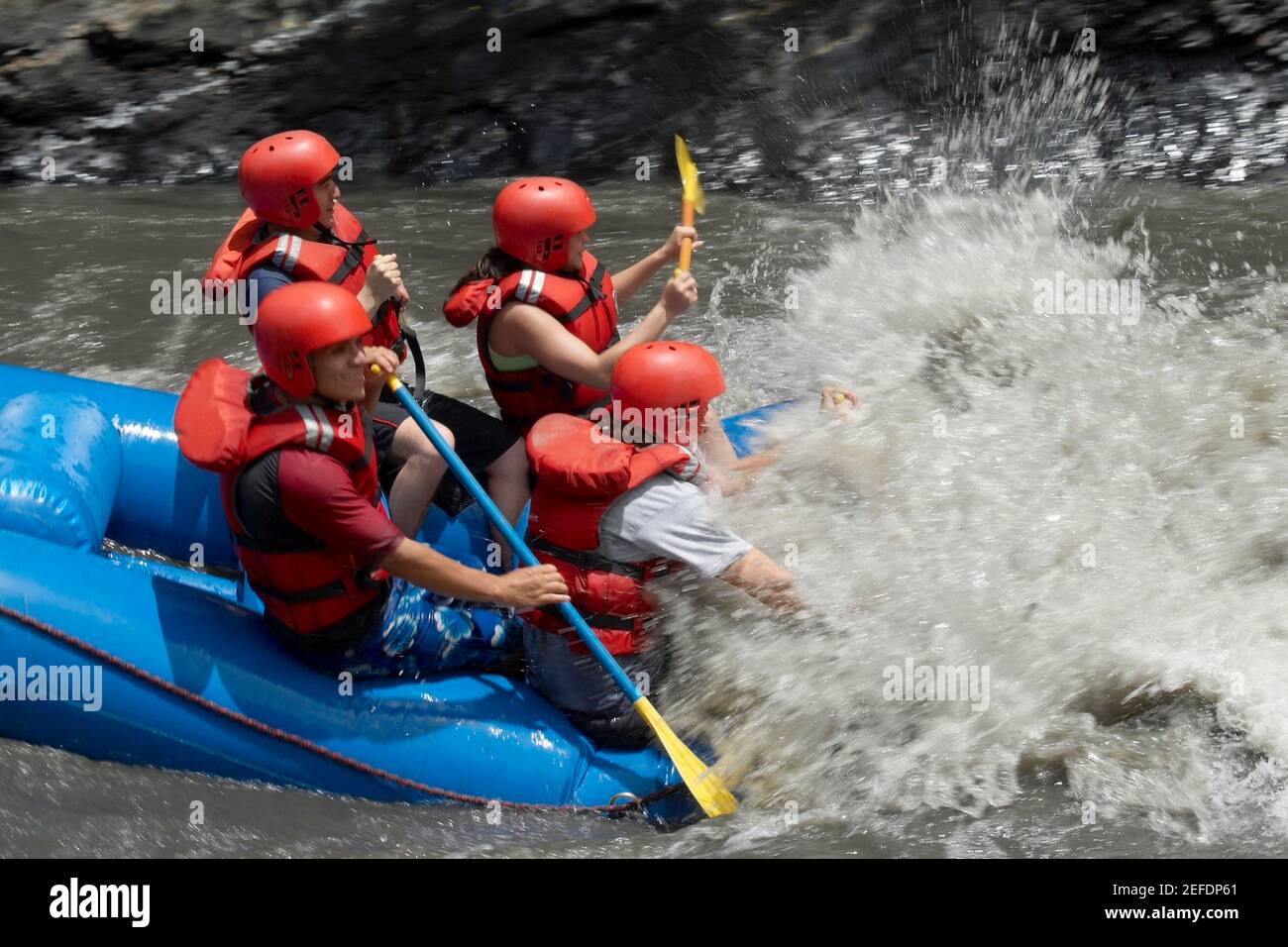 Side profile of four people rafting in a river Stock Photo - Alamy