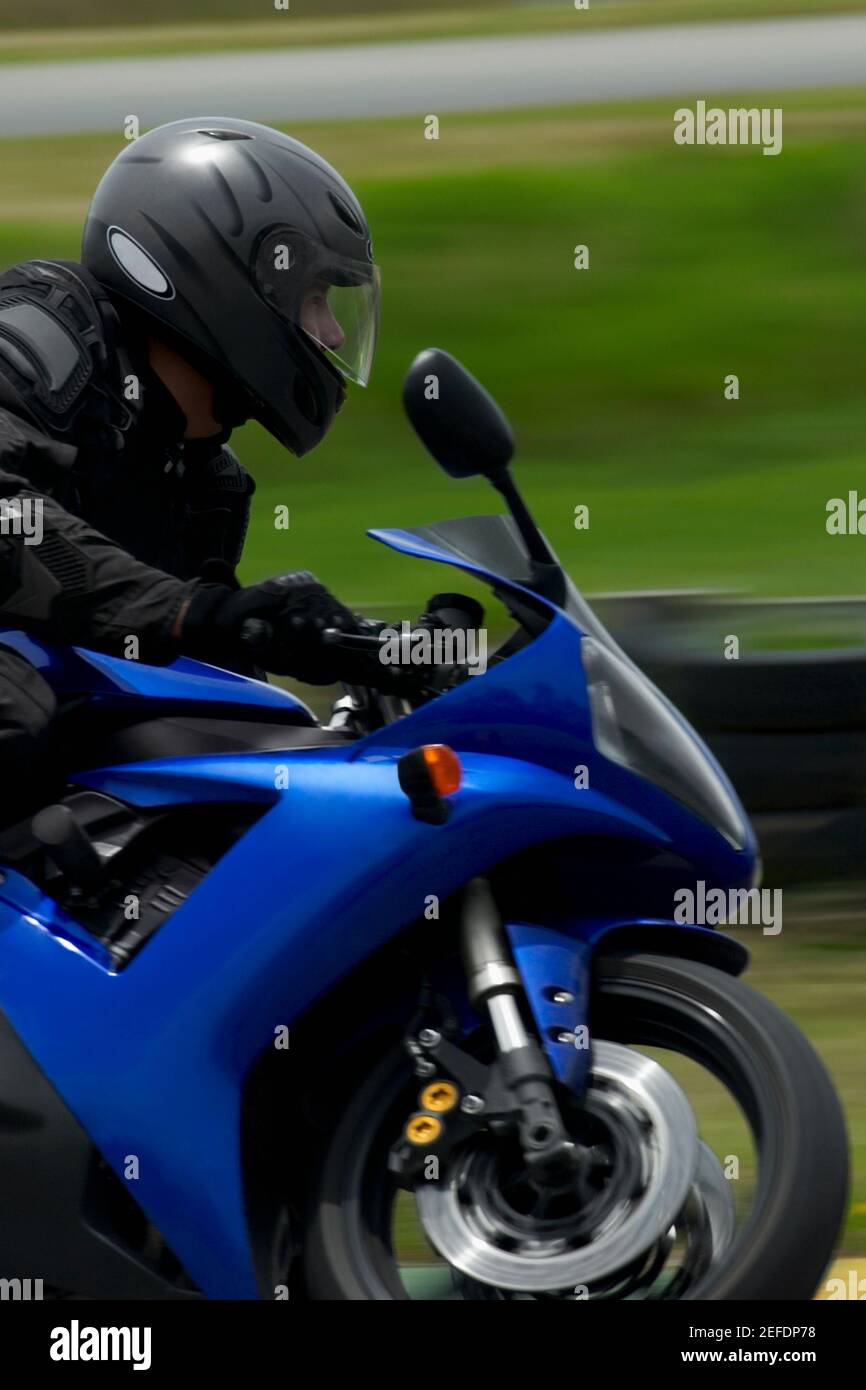 Side profile of a person riding a motorcycle Stock Photo - Alamy