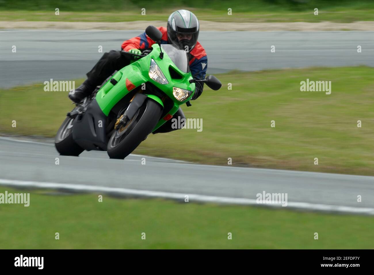 Person riding a motorcycle on a motor racing track Stock Photo - Alamy