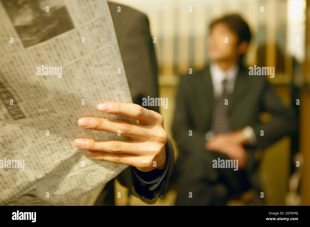 Man holding a newspaper Stock Photo - Alamy