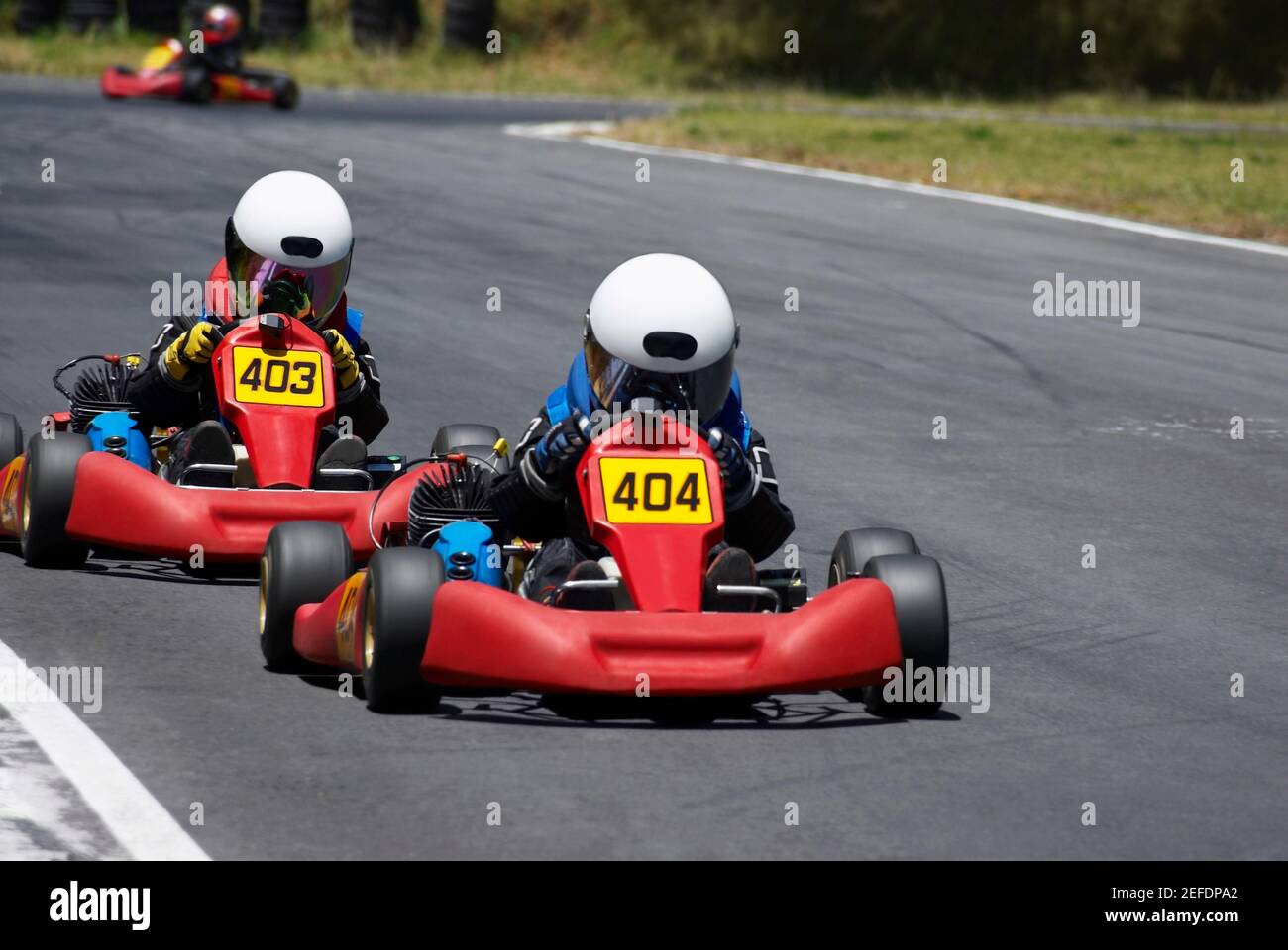 Two people go-carting on a motor racing track Stock Photo - Alamy