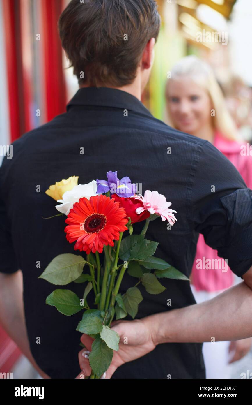 Holding flowers behind back hi-res stock photography and images - Alamy